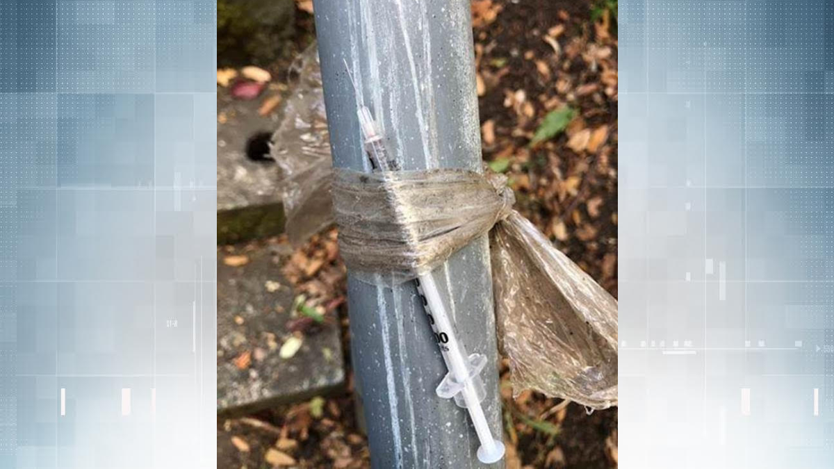 Used needle with small amount of blood discovered taped to handrail at ...