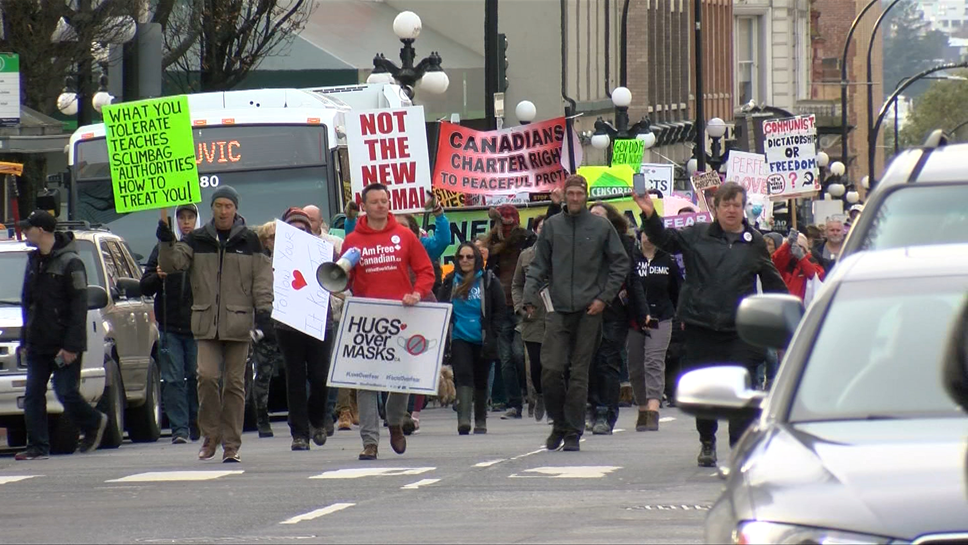 Anti-mask protesters march through downtown Victoria, hold rally