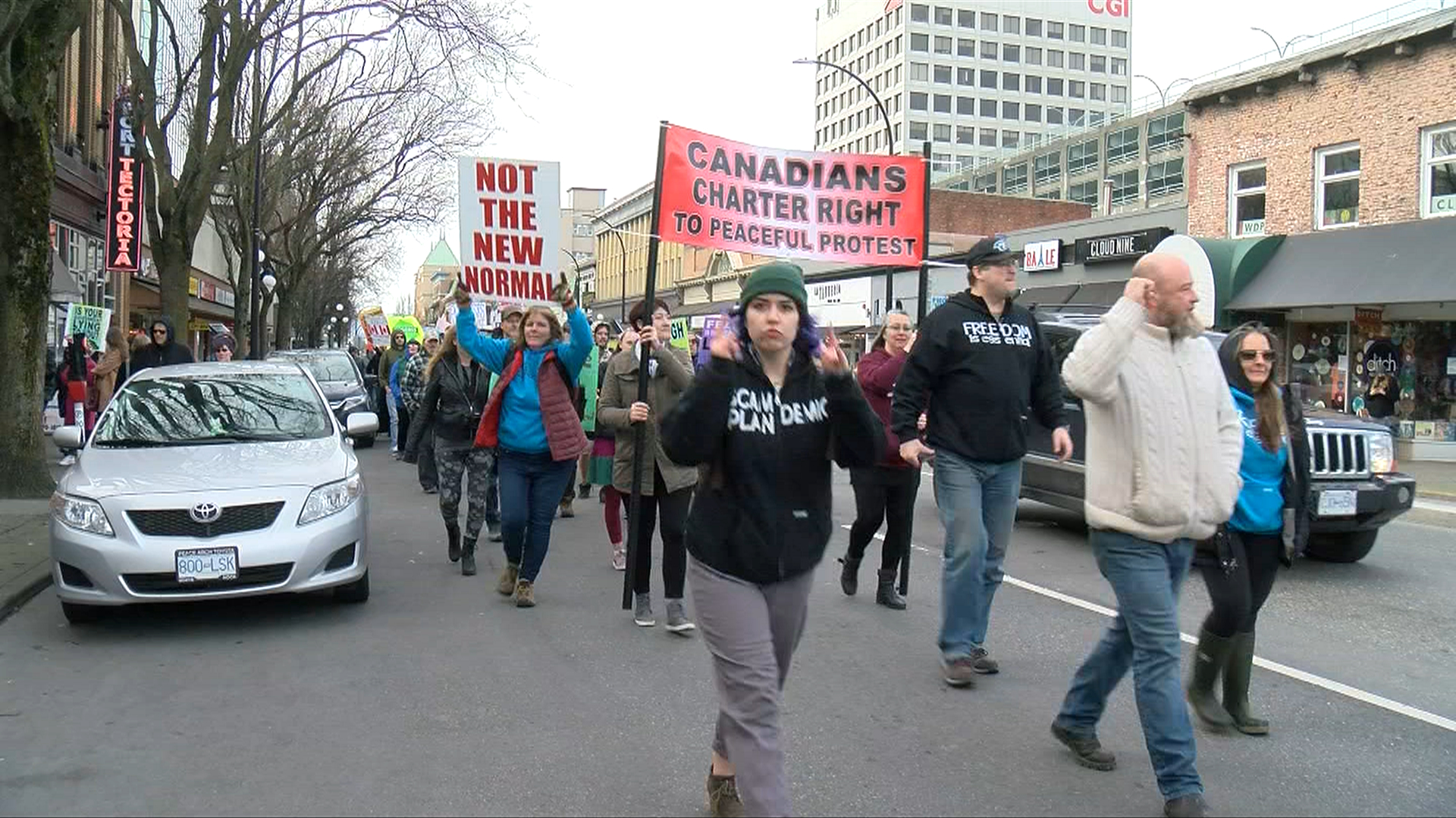 Anti-mask protesters march through downtown Victoria, hold rally