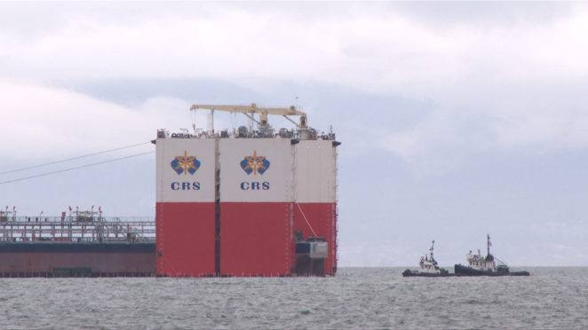 Massive semi-submersible cargo ship anchors near Victoria